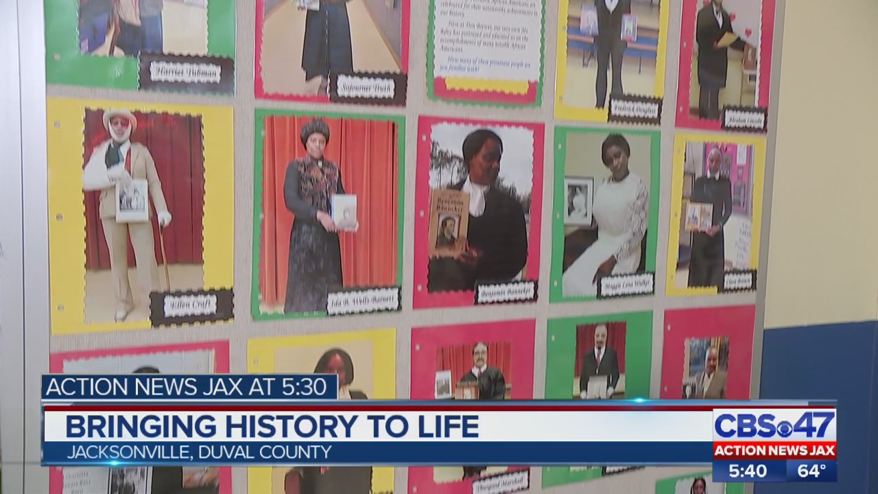 School employee greets students as African American role models during ...