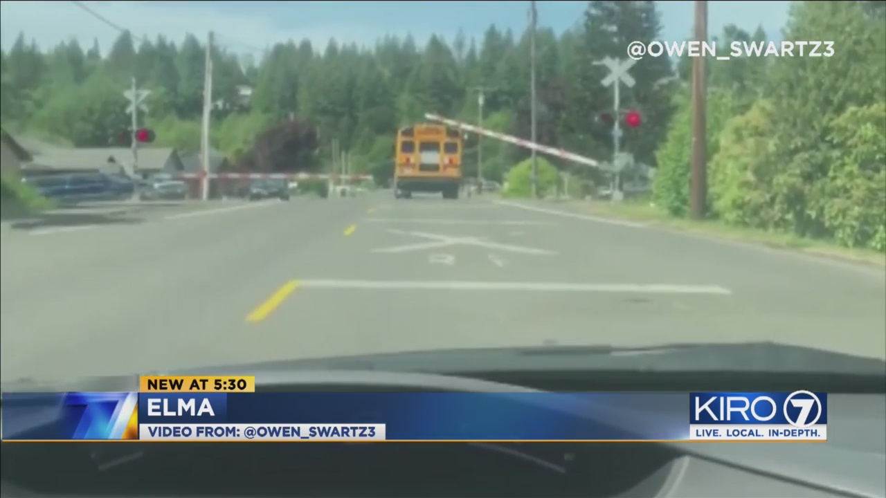 School bus hit by railroad crossing arm, drives over tracks ahead of ...