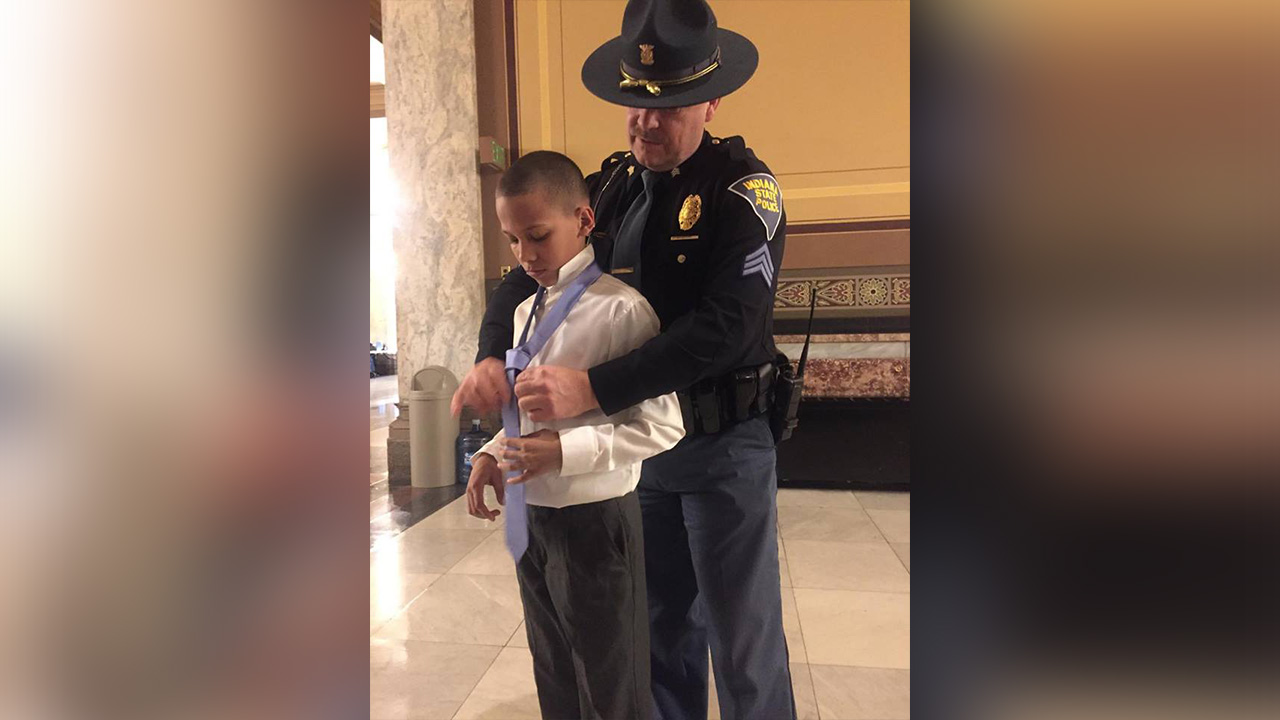 Police officer helps boy tie necktie in heartwarming viral photo