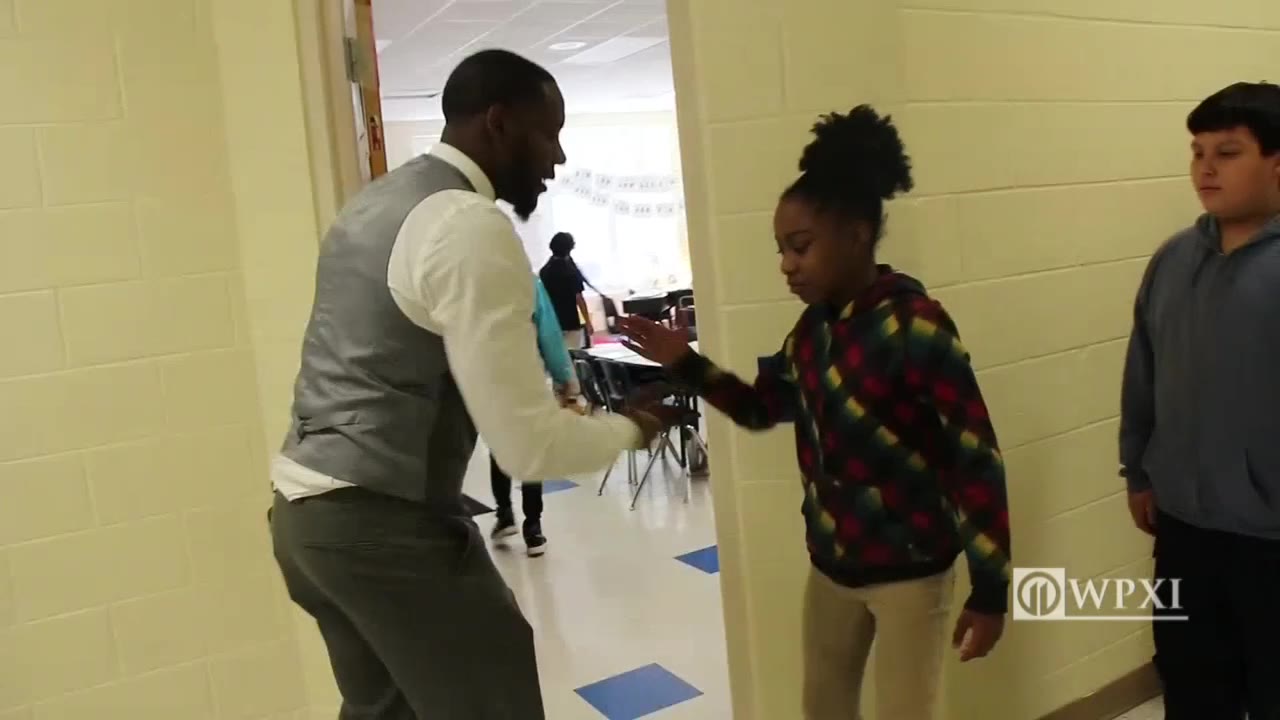 Teacher has special handshake for each of his students