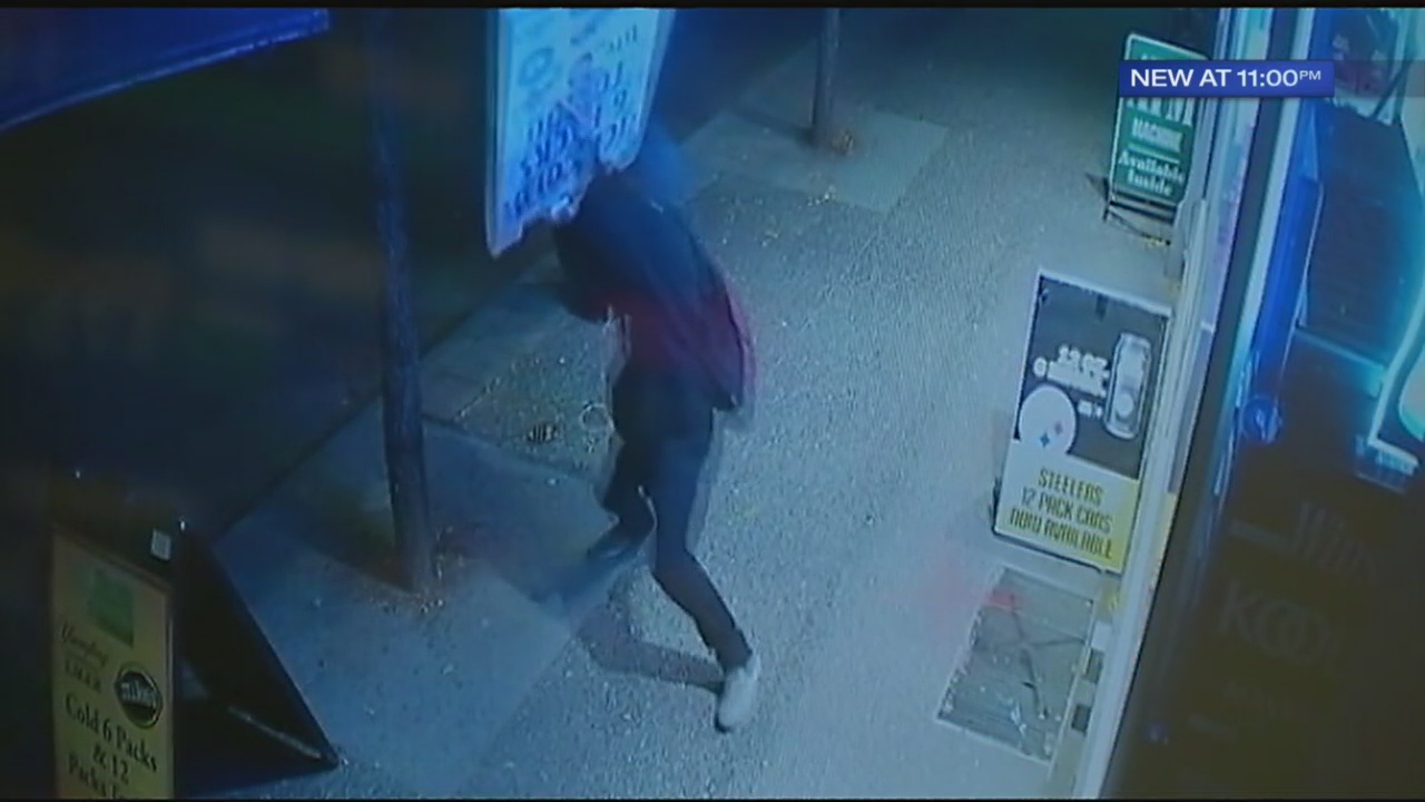 Man caught on camera throwing sign through window of downtown ...