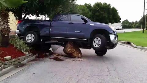Truck gets stuck on huge rock in front of Zaxby's